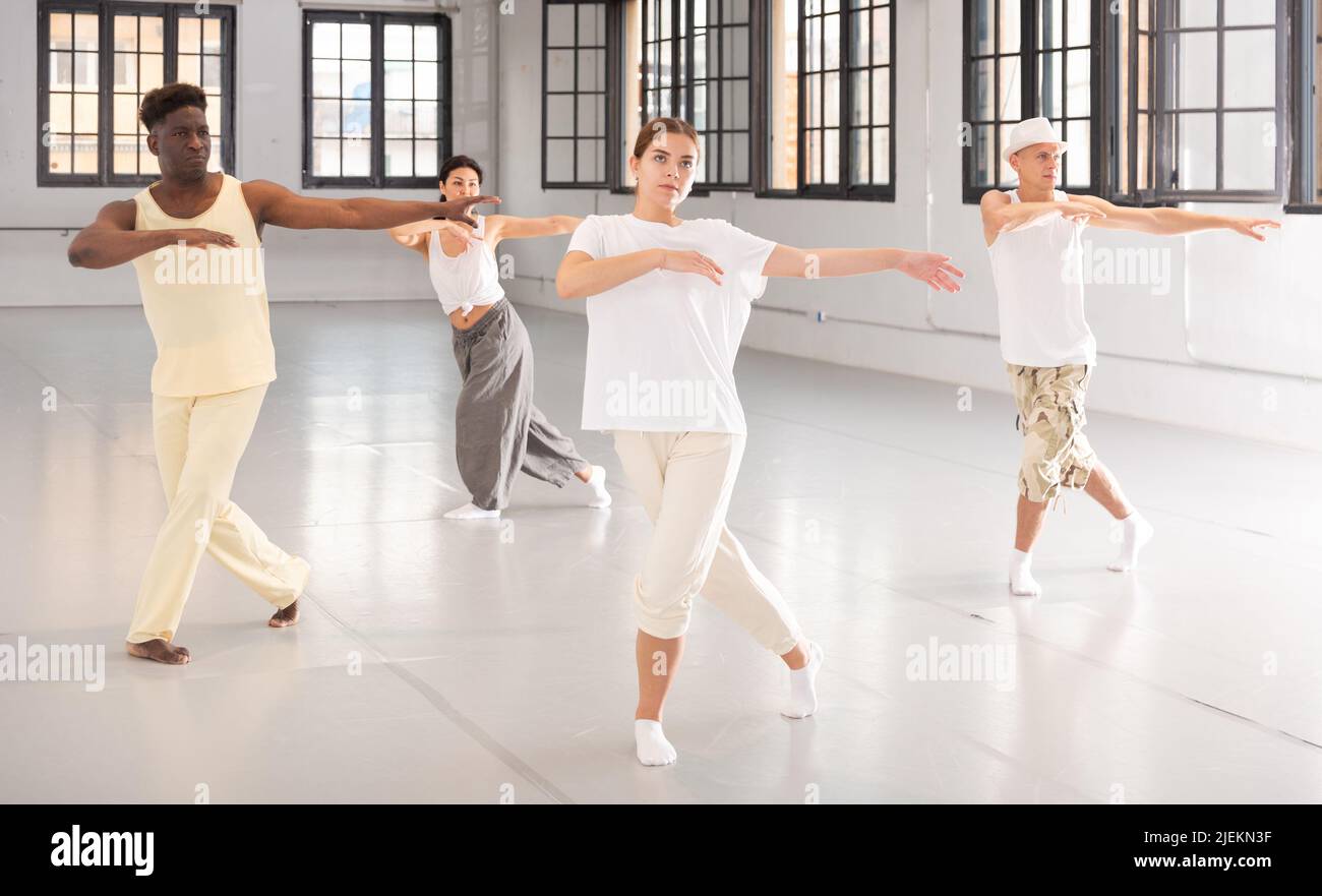 Four dancers exercising contemporary dance movements Stock Photo - Alamy