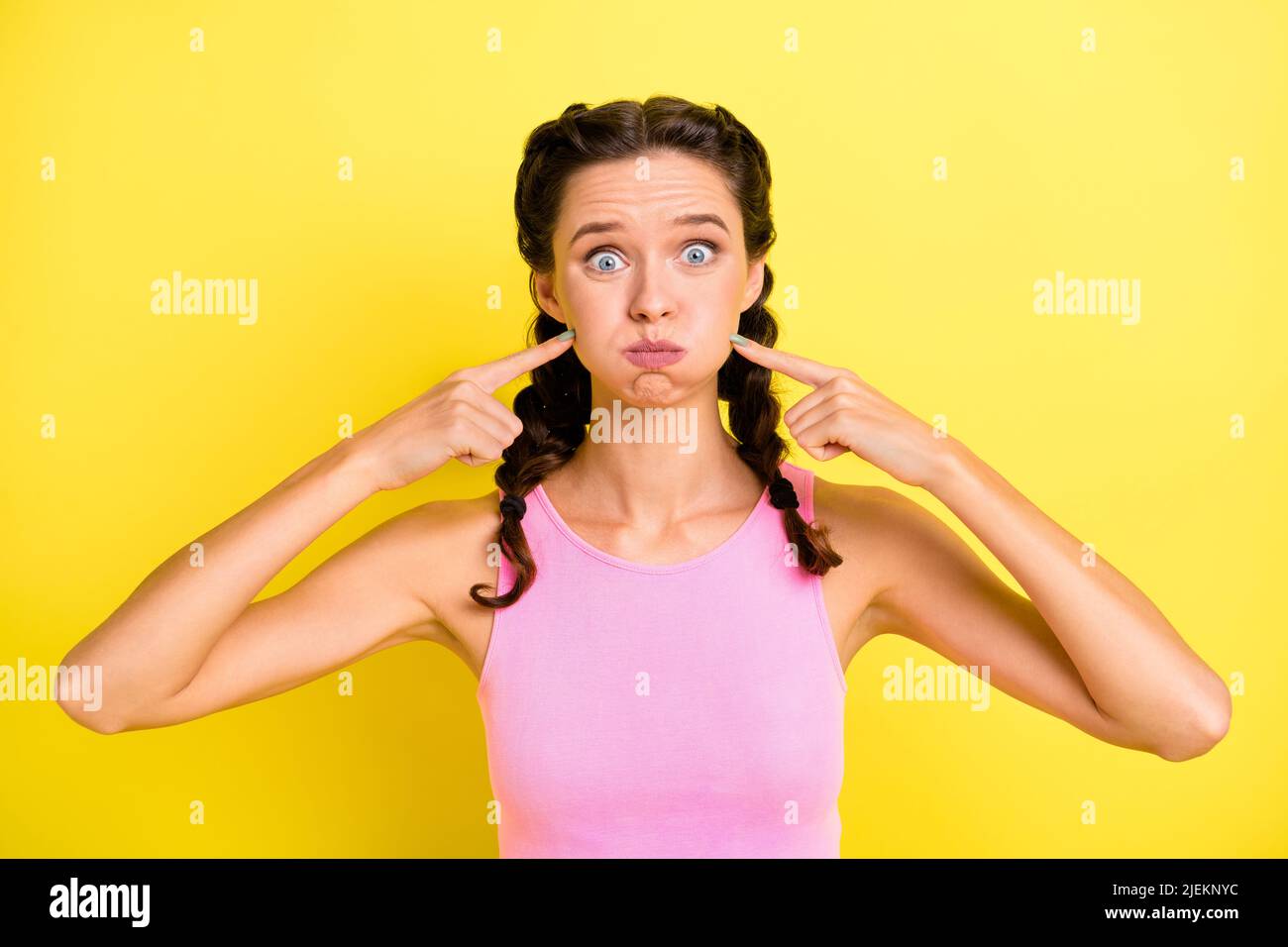 Photo of cute childish young woman pigtails wear tank top pointing ...
