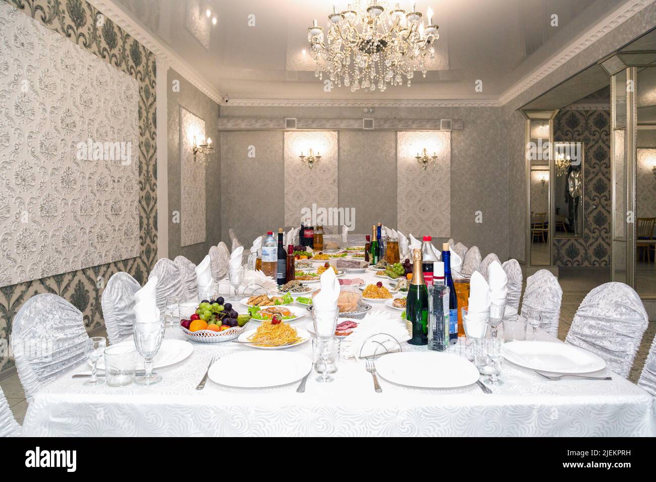 A large table for guests in the restaurant is covered with food and ...