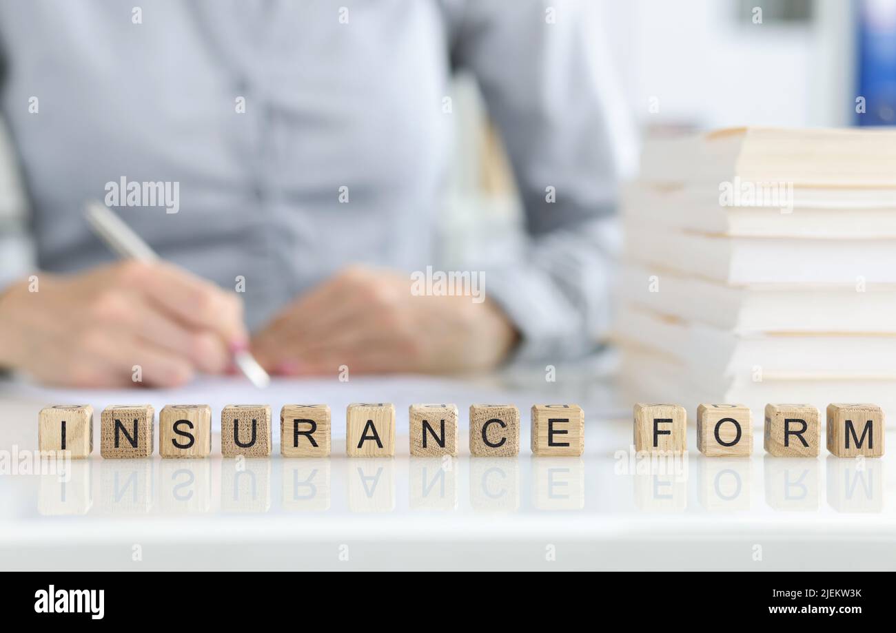 Claim form to fill out and insurance agent Stock Photo - Alamy