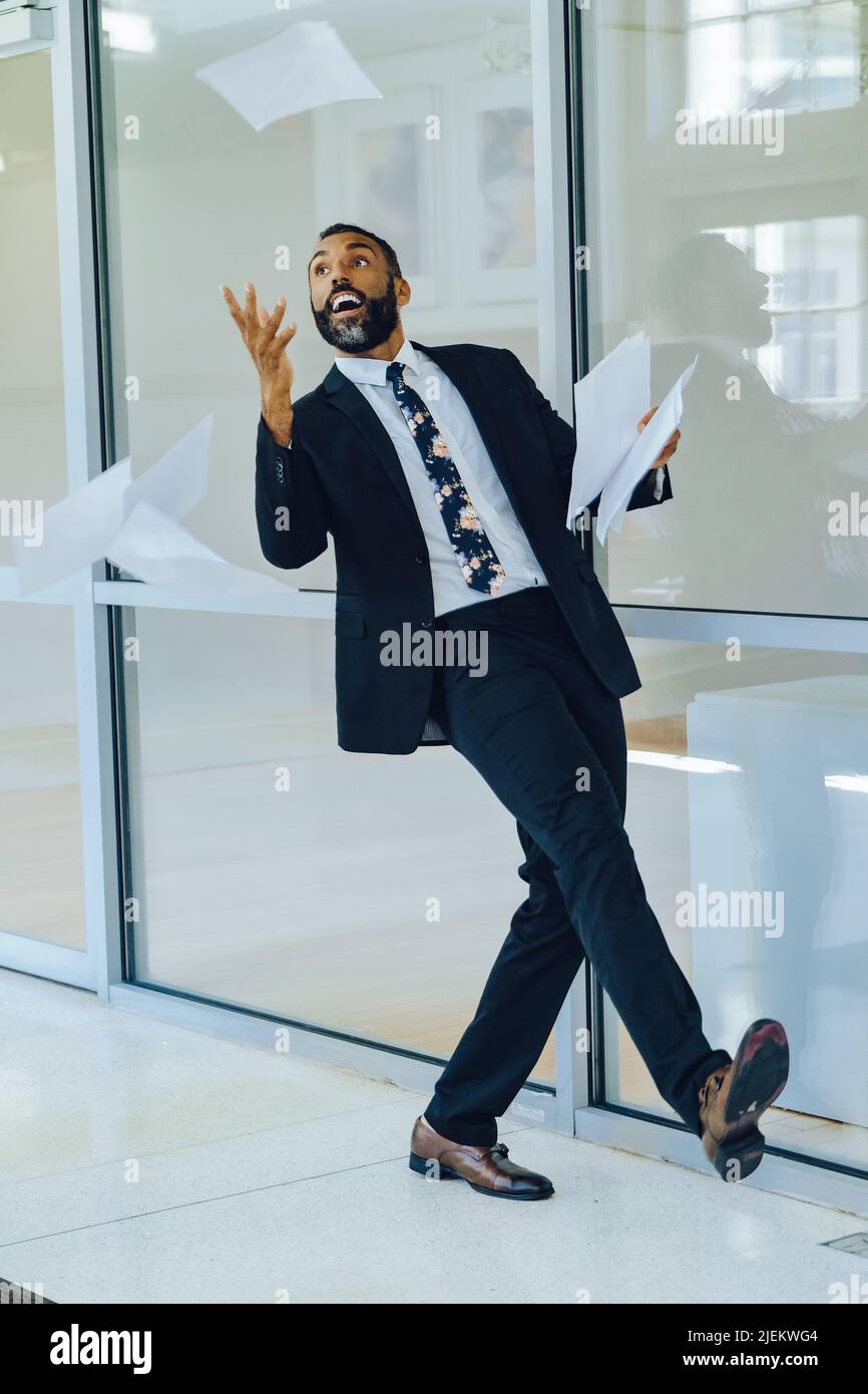 Business success laughing African American businessman throwing papers ...
