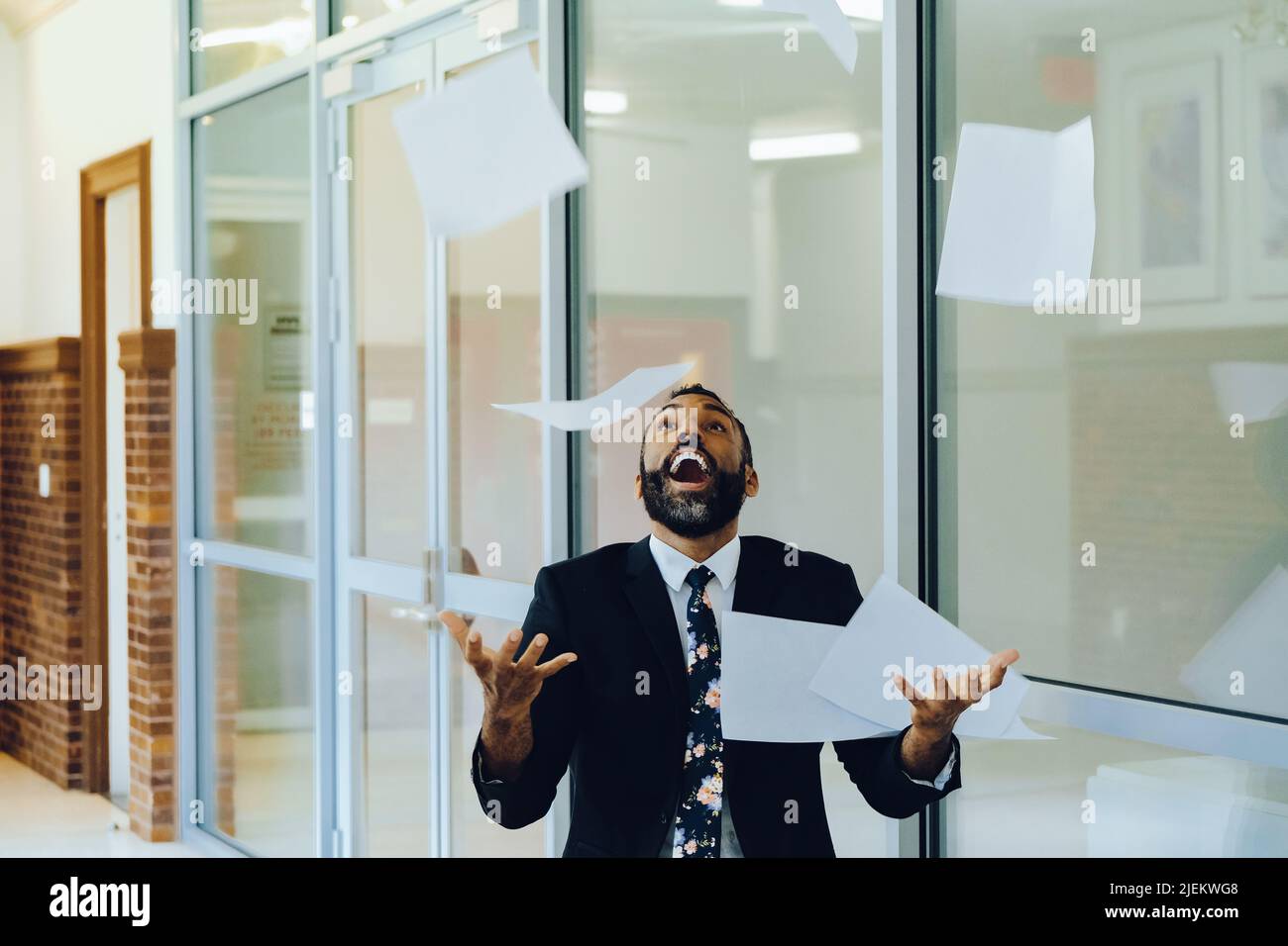 Business success laughing African American businessman throwing papers ...