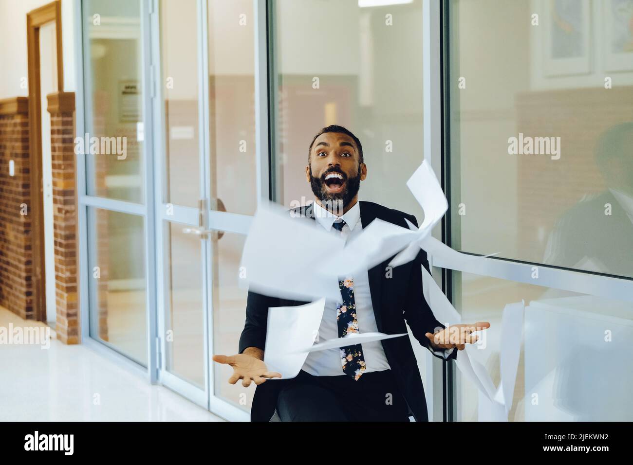Business success laughing African American businessman throwing papers ...