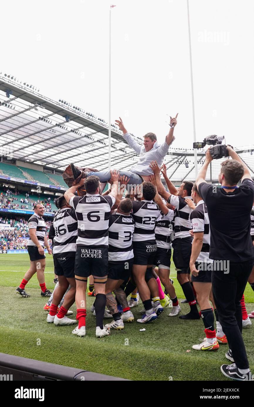 Barbarians players hold a pitch invader above their heads after the ...