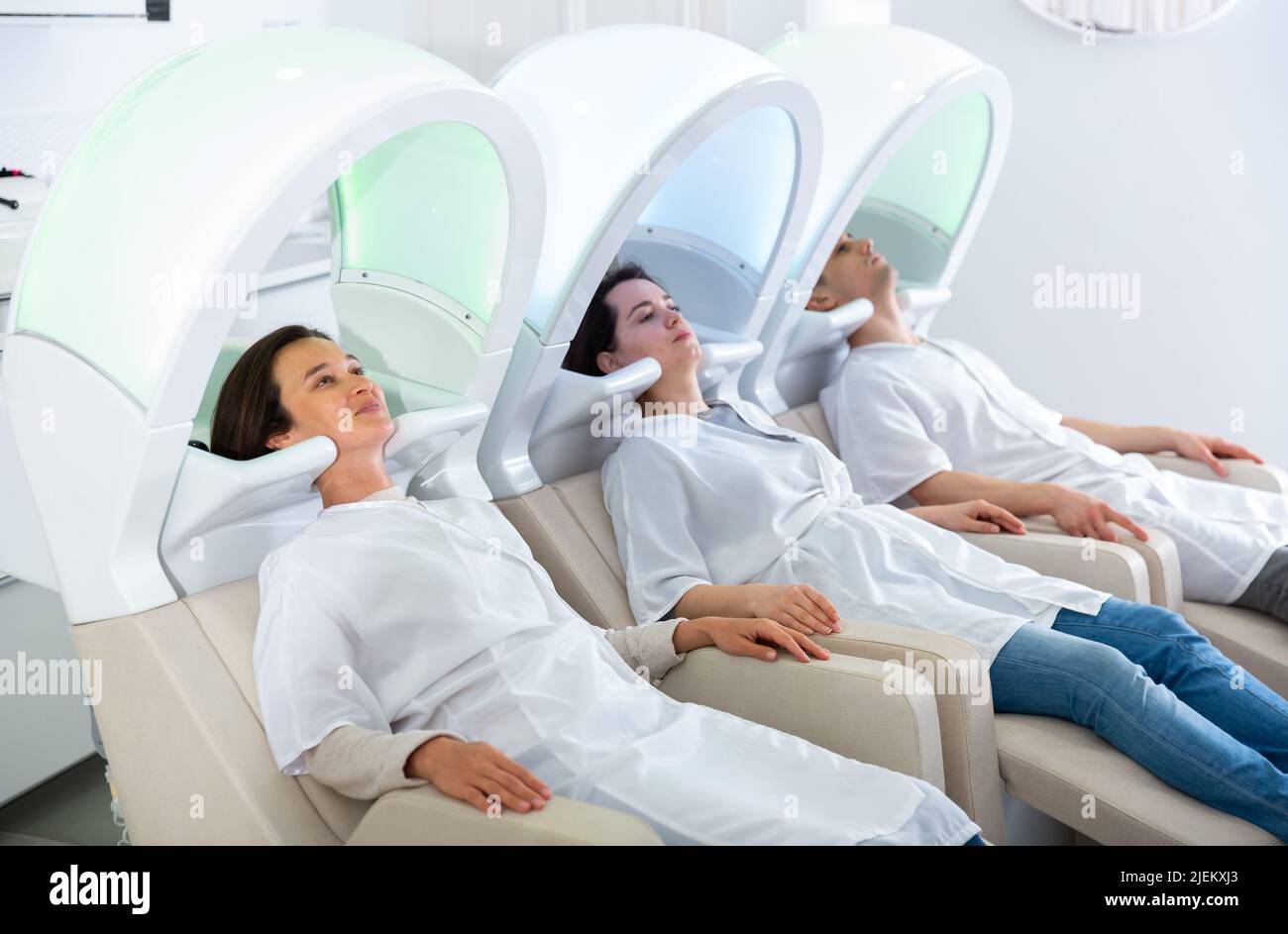 Clients of beauty salon relaxing on massaging chairs Stock Photo - Alamy