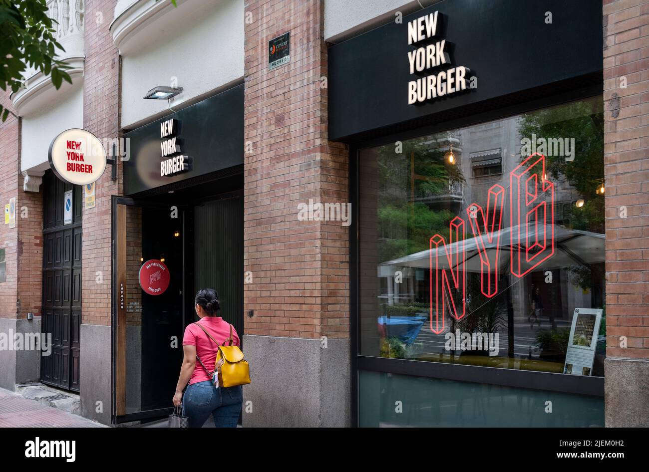 A pedestrian walks past the hamburger fast food restaurant chain New ...