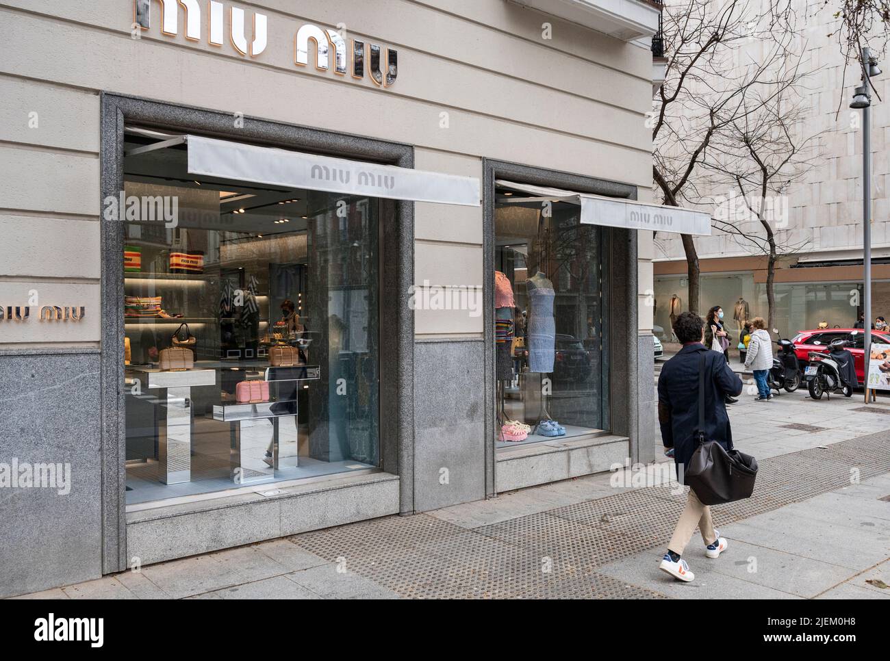 A pedestrian walks past the Italian high fashion women's clothing and ...