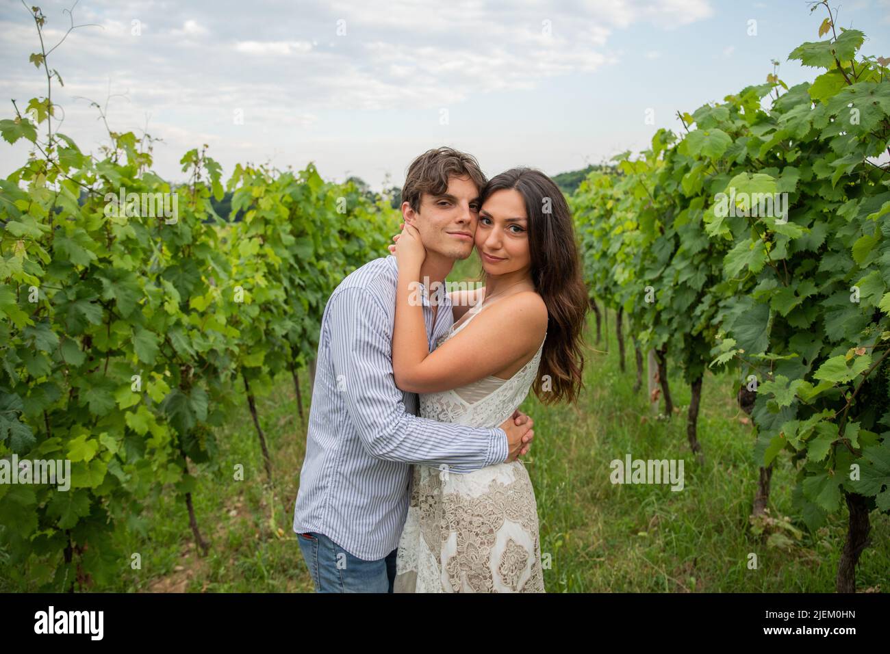 Boy and girl in love look smilingly at the photographer who portrays ...
