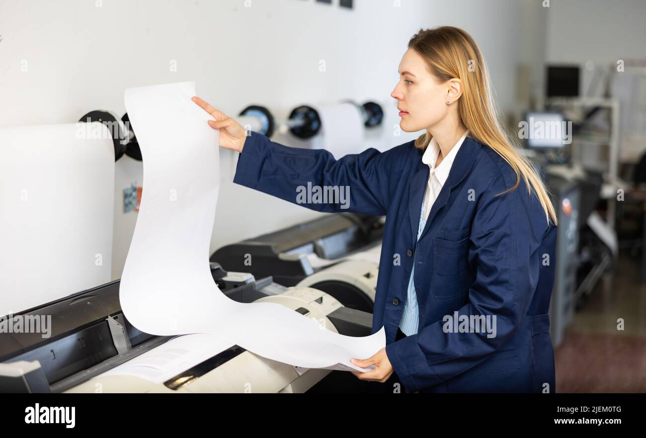 Woman working in printing office, using printer Stock Photo - Alamy