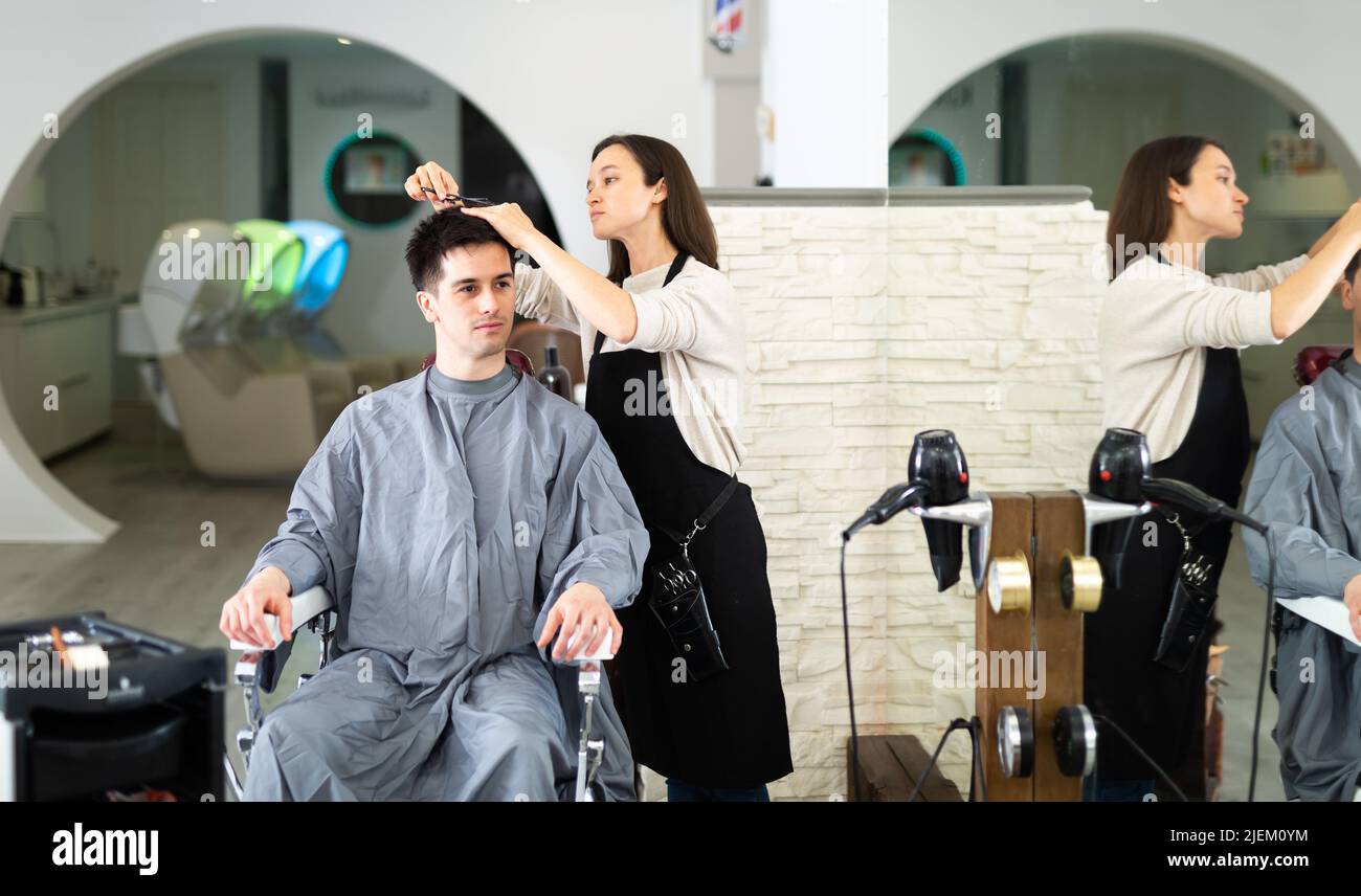 Female barber haircut doing male hi-res stock photography and images ...
