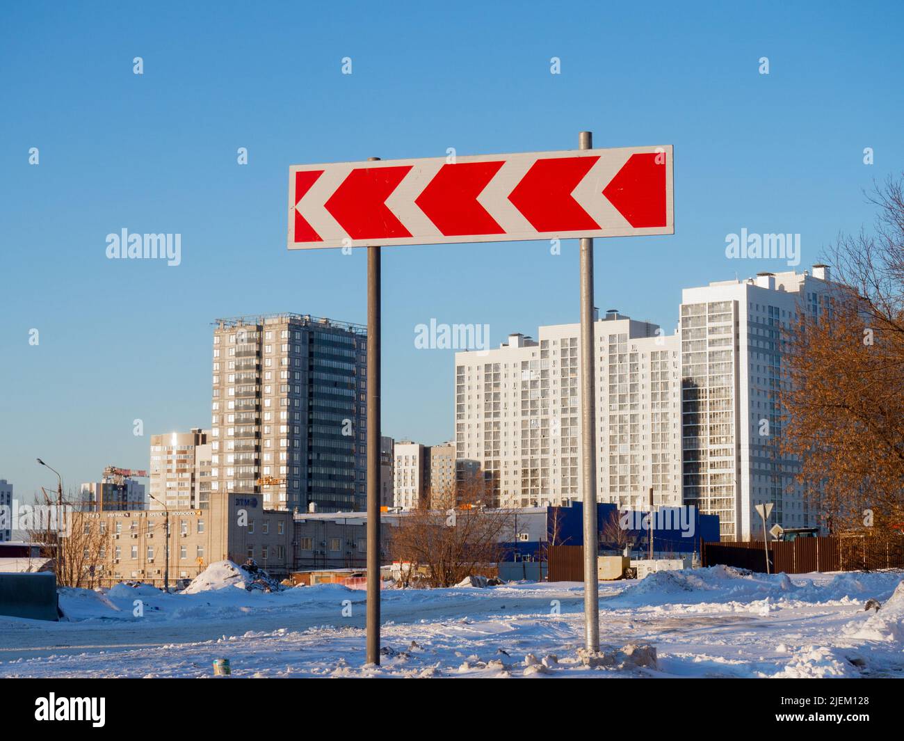 Direction indicator on the background of a high-rise building. Road ...