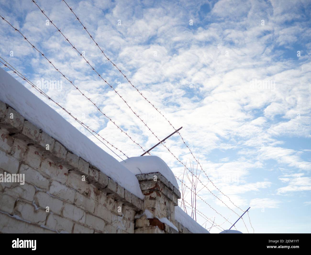 barbed wire and sky. Wire on the wall. Ingress protection Stock Photo ...