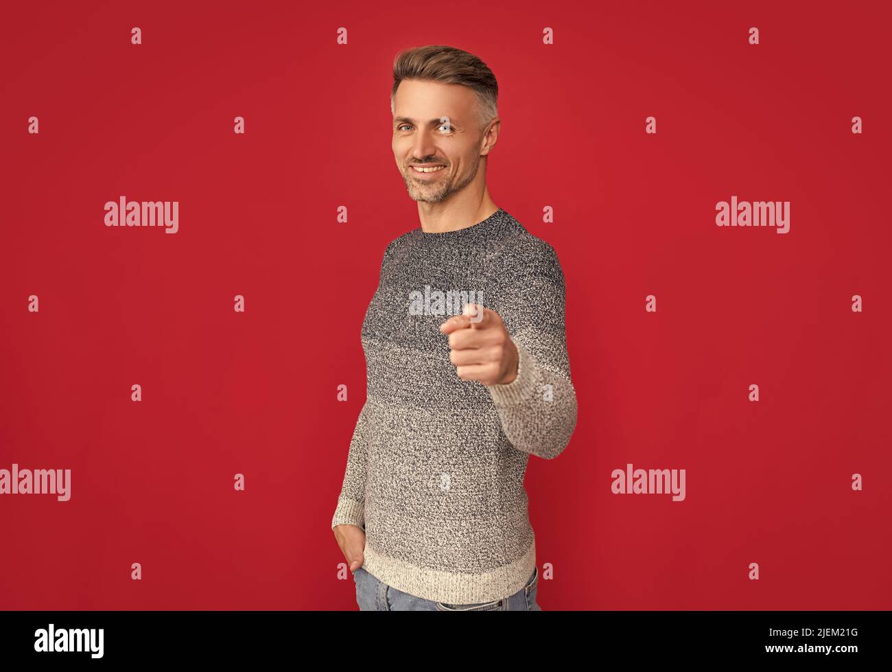 hair and skin care. happy grizzled guy in sweater on red background ...