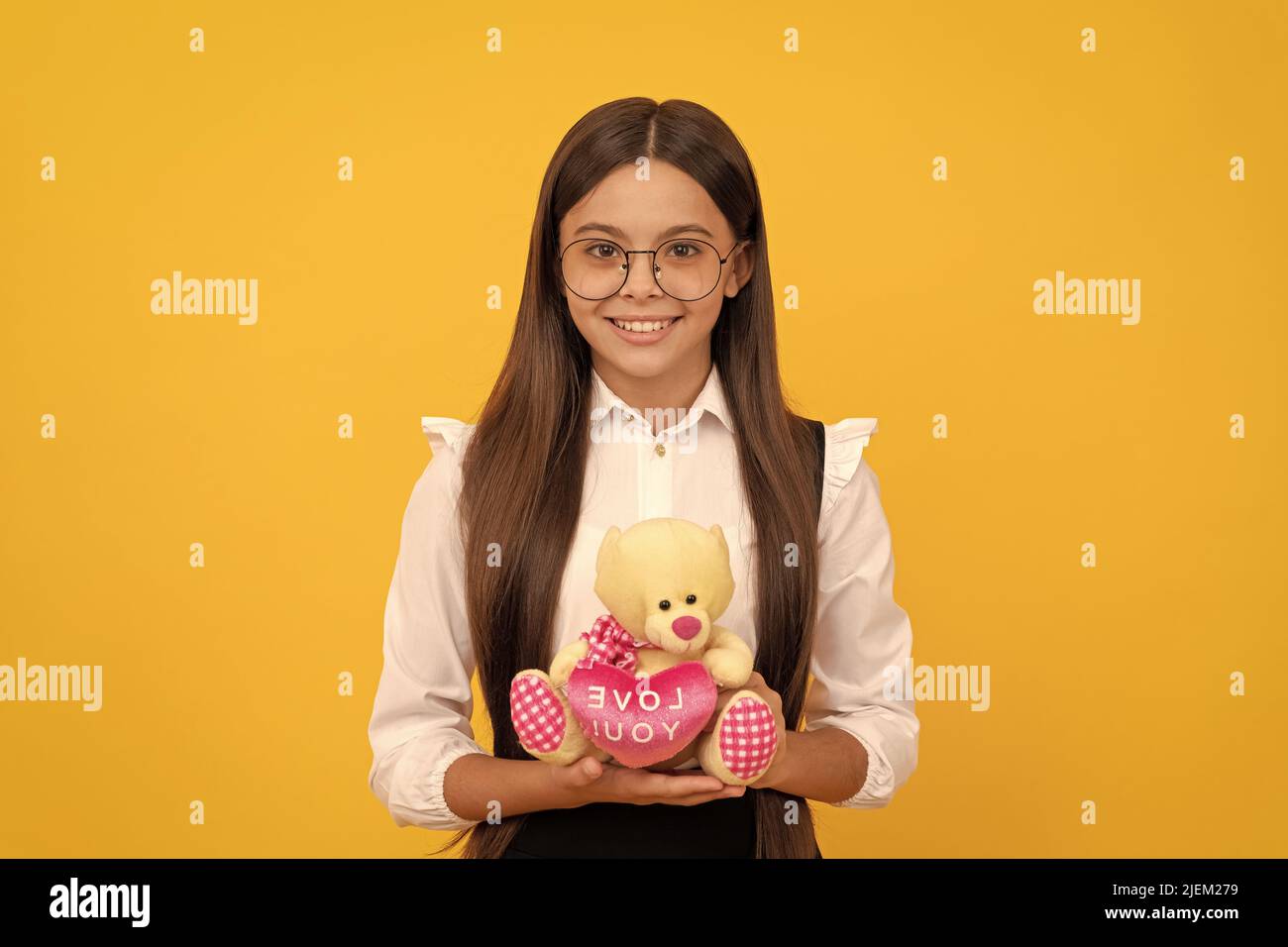 Love you with all my heart. Happy child smile holding teddy bear. Love ...