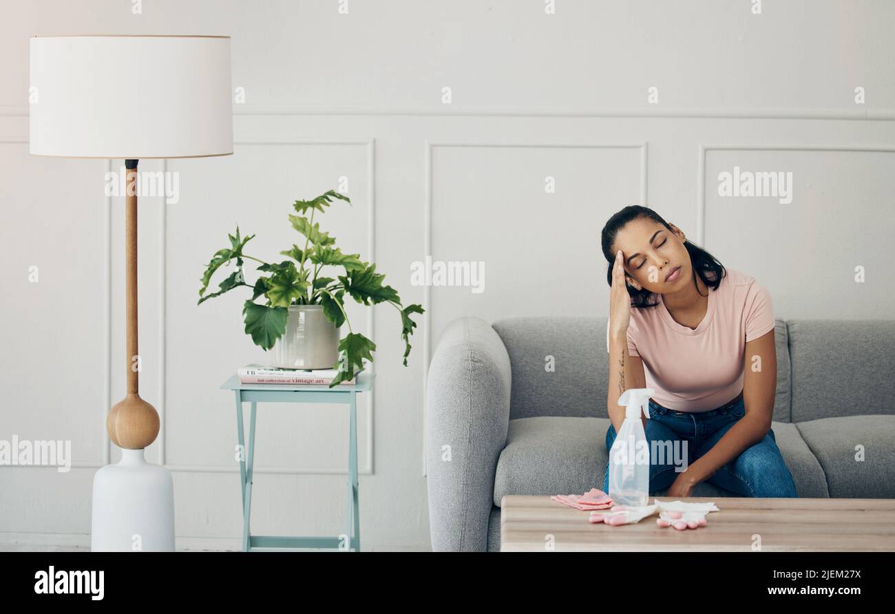 Shot of a woman looking stressed while busy cleaning at home Stock ...