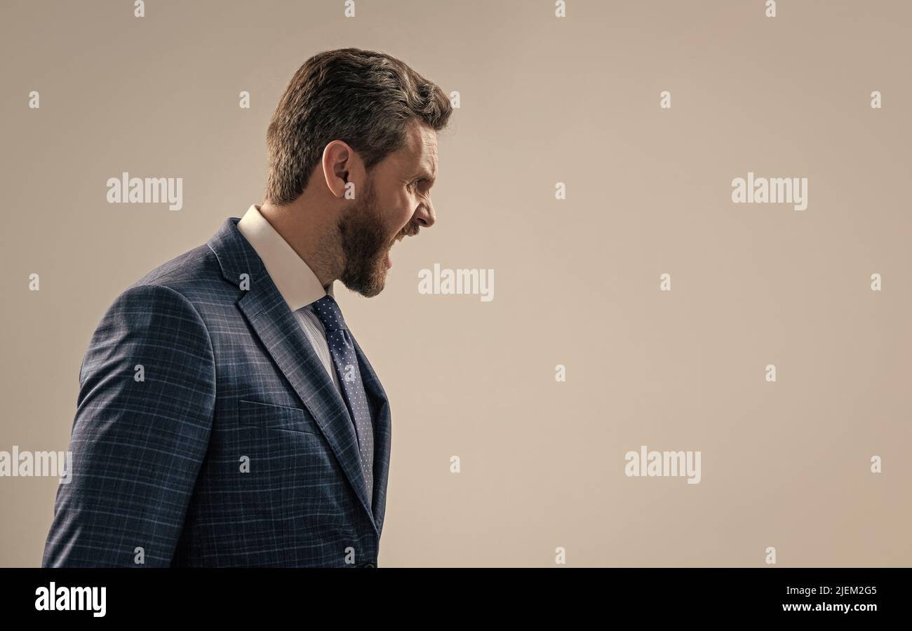 You make me yell. Angry guy side-face yell grey background. Businessman ...
