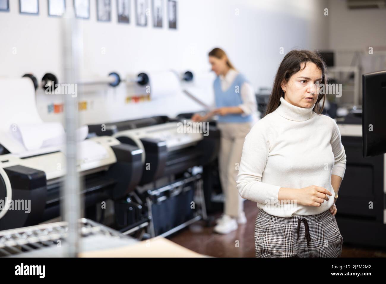 Technician operator calibrating plotter machine, typing on computer keyboard Stock Photo - Alamy