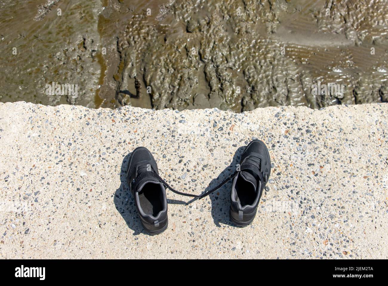 The abandoned shoes at the rim of construction over mud, top view Stock ...