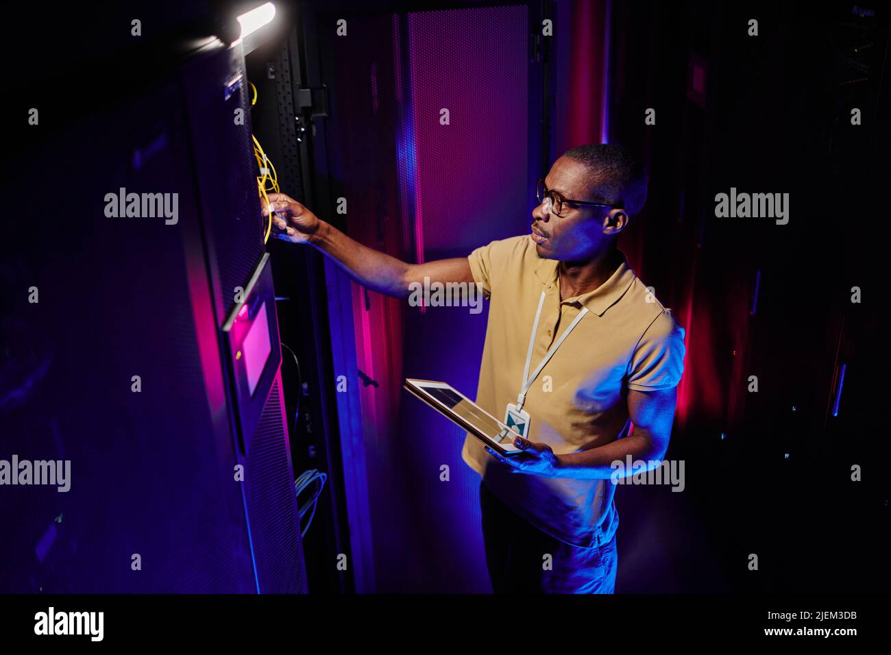 High angle shot of system administrator setting up server network in ...