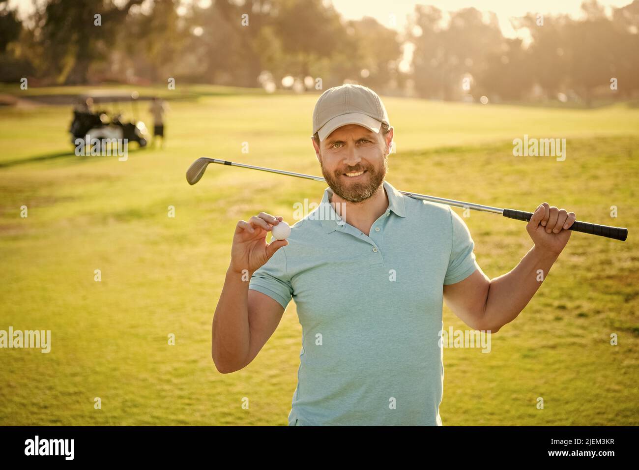 portrait of happy golfer in cap with golf club showing ball, golf Stock ...