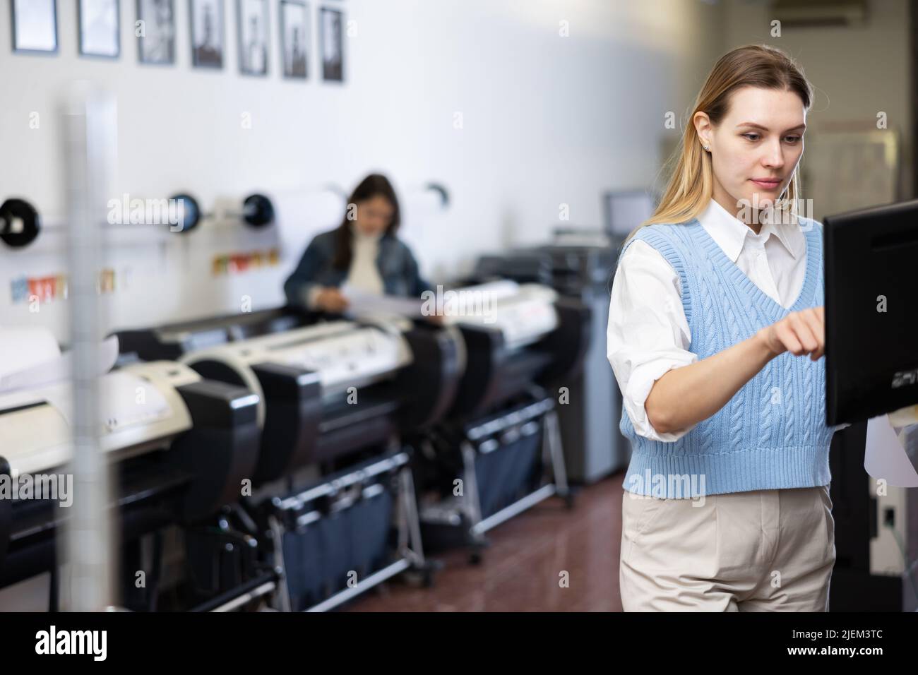 Technician operator calibrating plotter machine, typing on computer keyboard Stock Photo - Alamy
