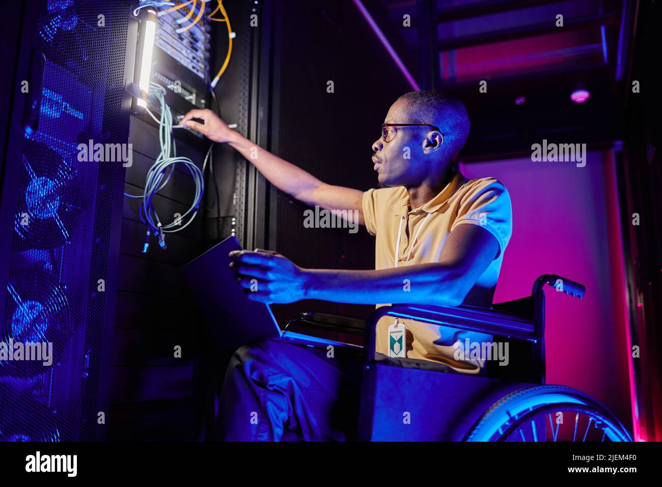 Side view portrait of person with disability working at system ...