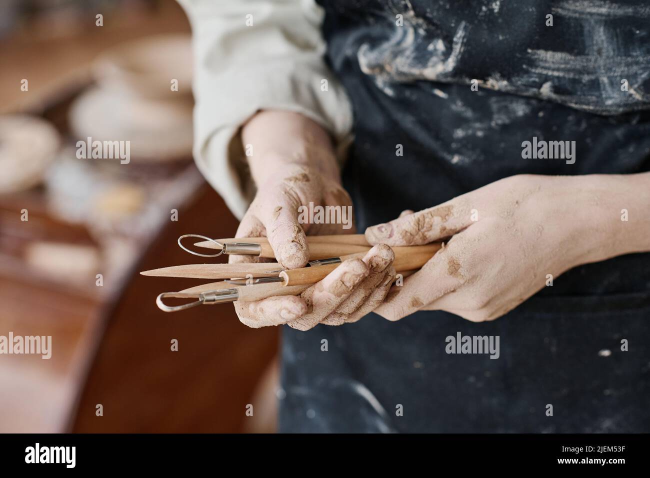 Hands of young female creative artisan holding bunch of wooden ...