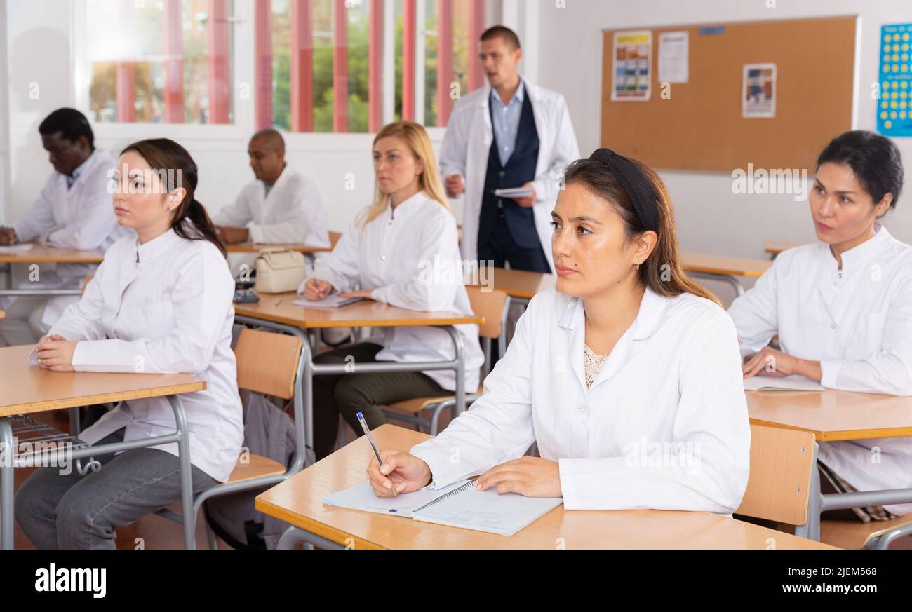 Group of adult medical students listening to lecture in classroom Stock ...