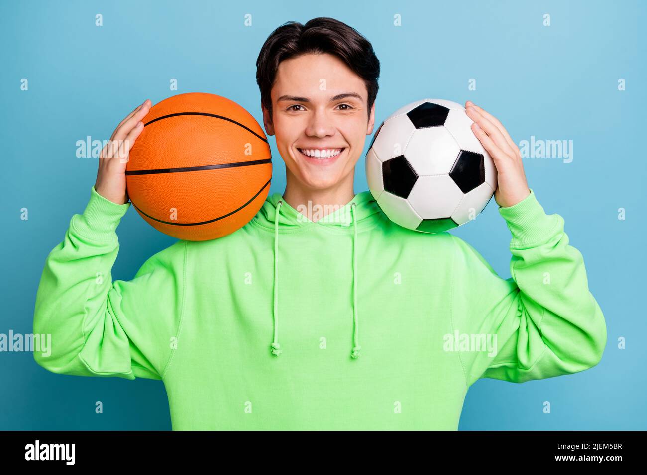 Photo of positive coach guy hold two balls toothy beaming smile wear ...