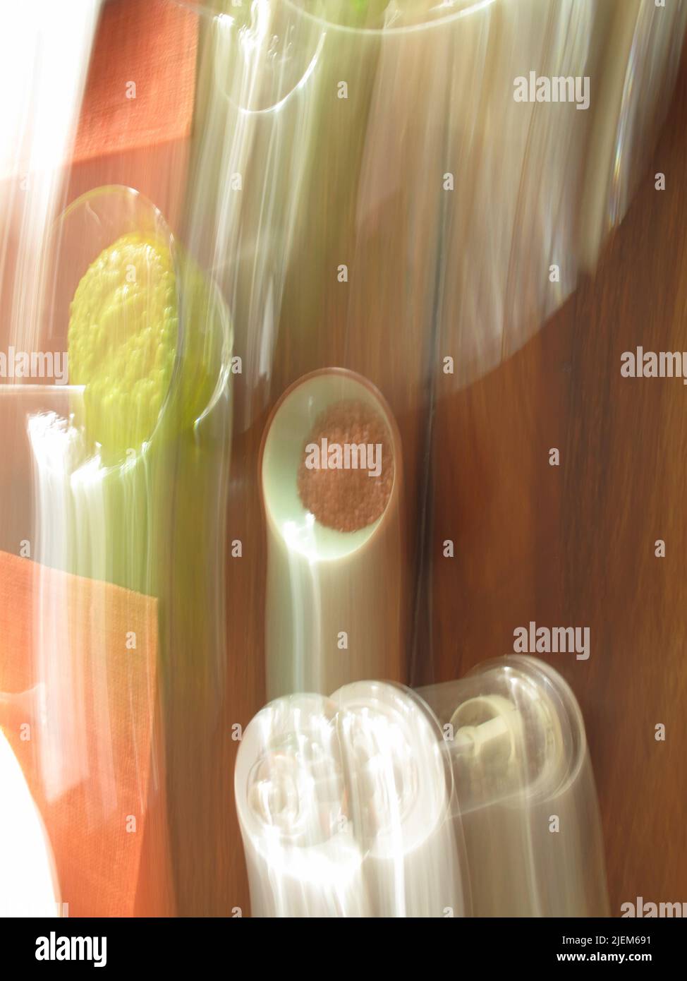 Motion blur, blurred, defocused view of food and spices on a wooden ...