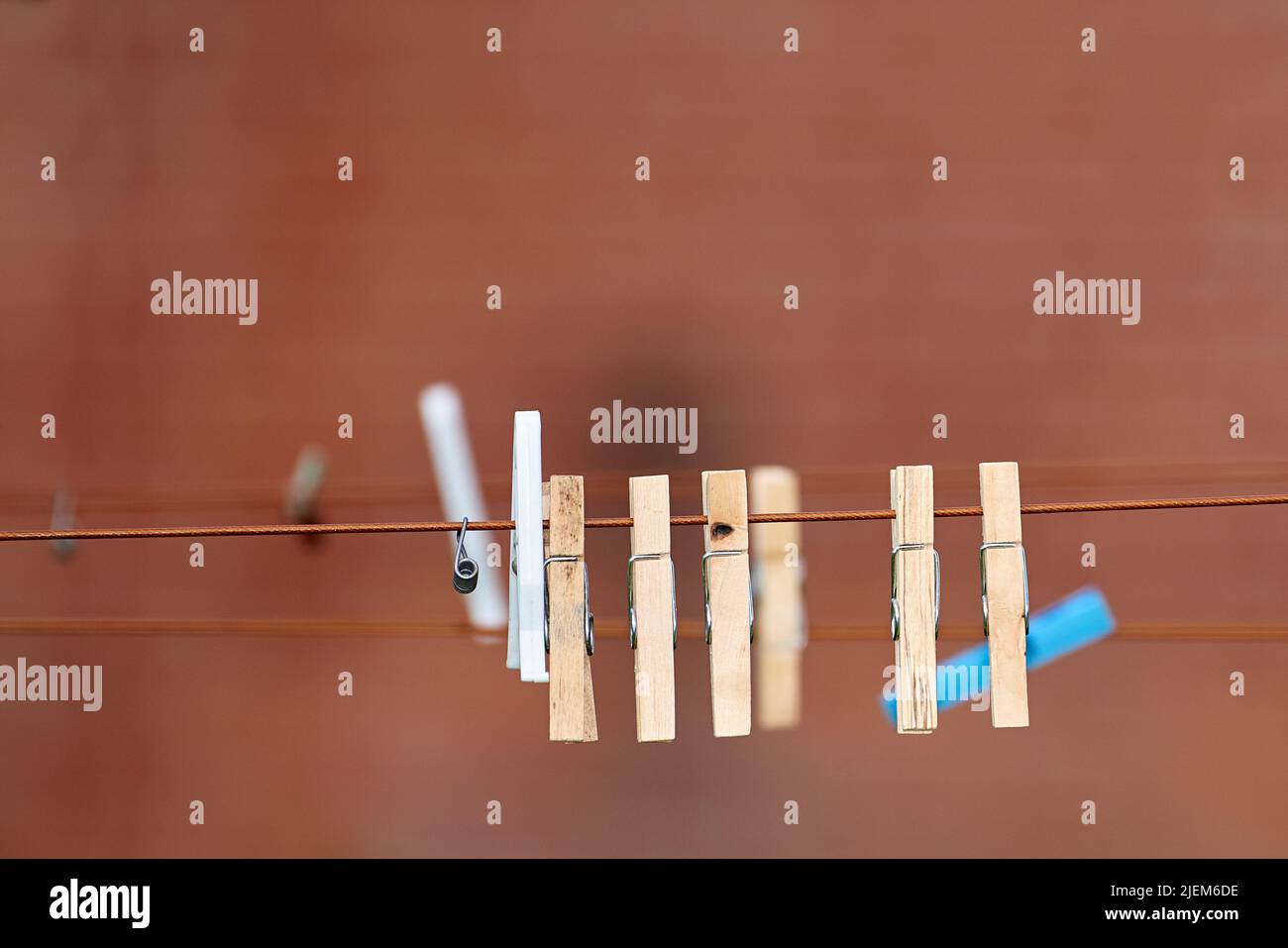 Many wooden washing pegs on a line. Old wooden clothespins hanging on ...