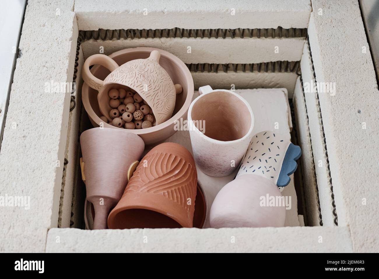 Part of concrete or ceramic square container with group of handmade ...