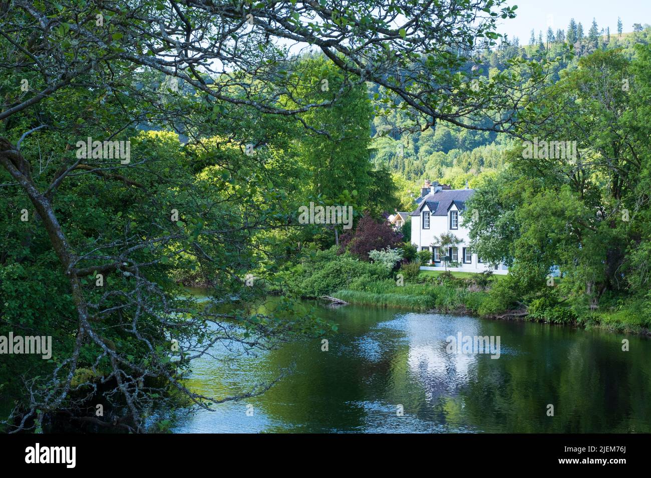 White painted house with loch view in remote area in the highlands of ...