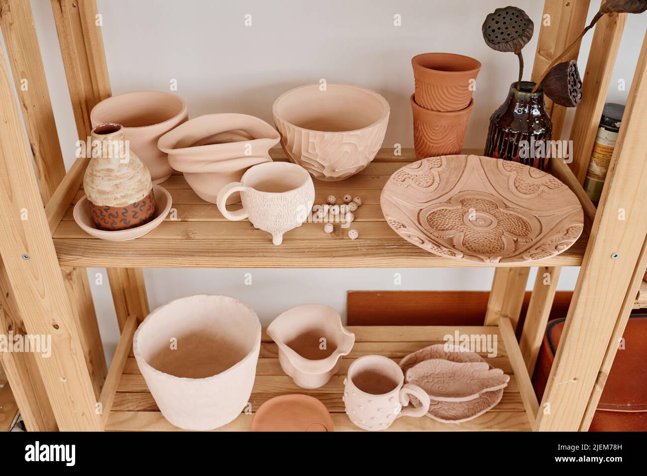 Assortment of handmade clay items on display consisting of wooden ...