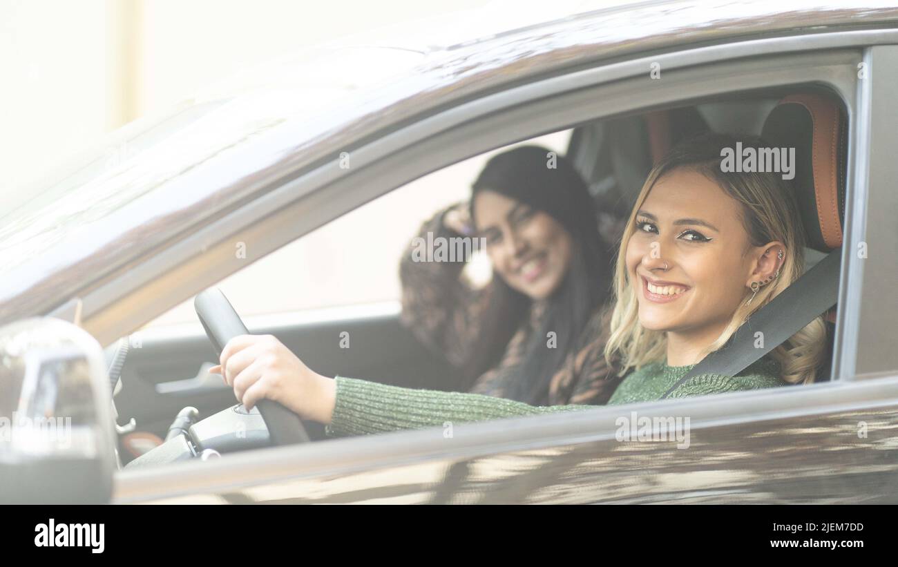 Two Young women smiling in a car enjoying a road tripping concept best ...
