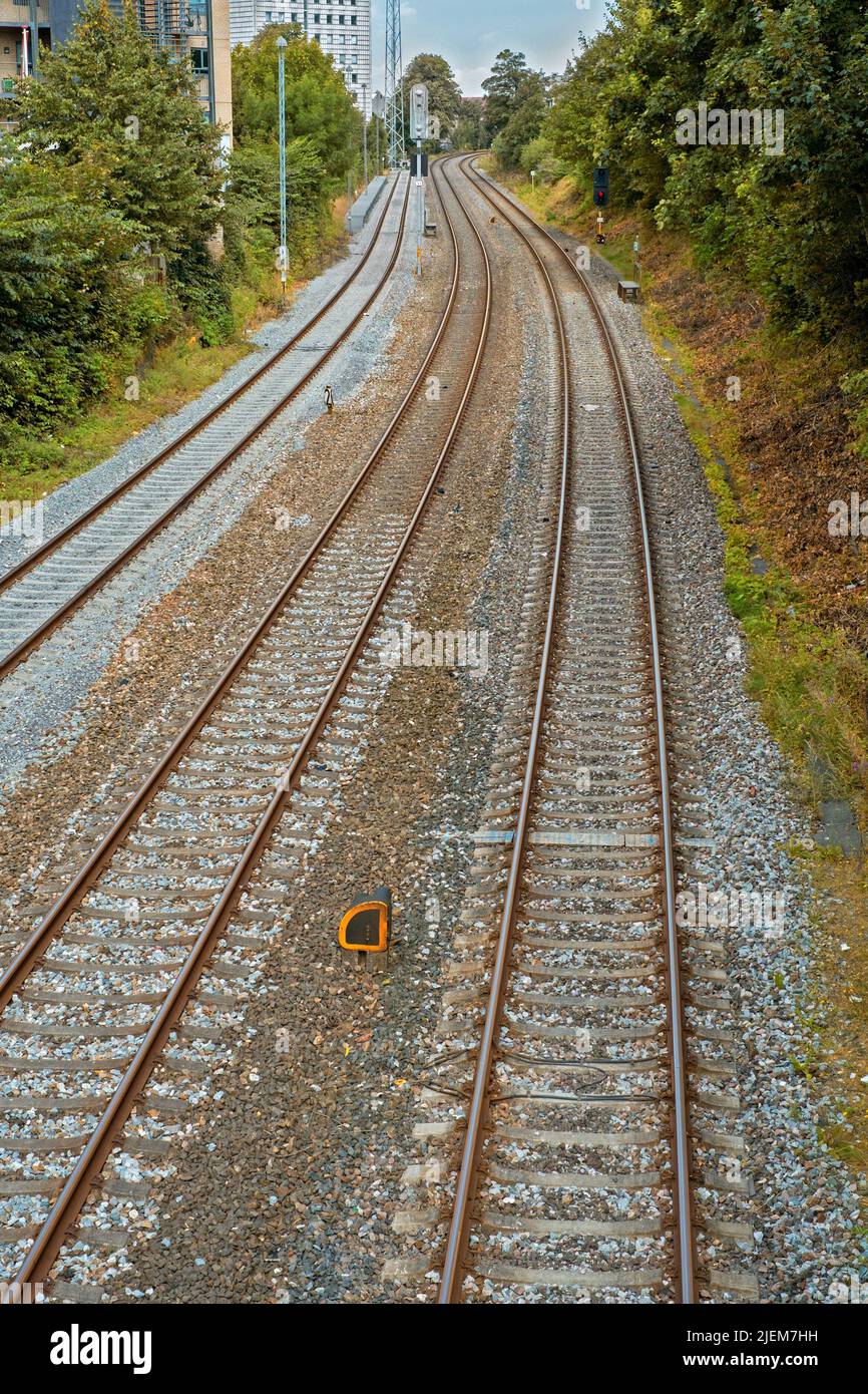 View of three old railway tracks leading out of a city in Denmark ...