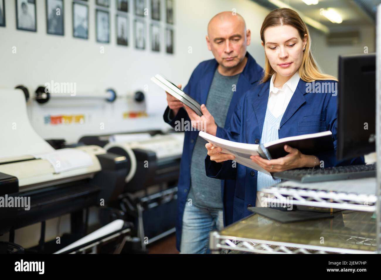 Woman printing office worker reading operation manual Stock Photo - Alamy