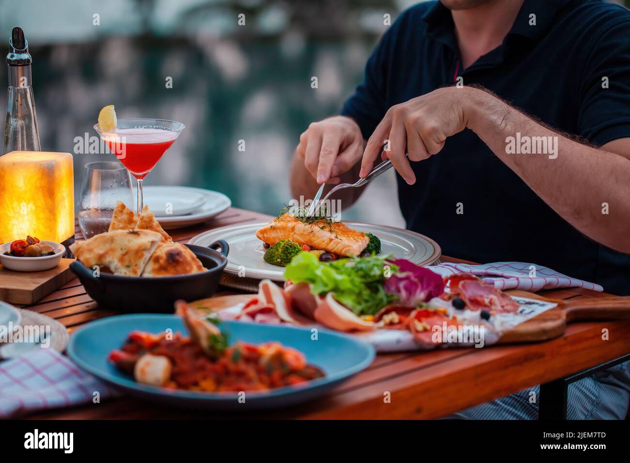 Man on luxury dinner served on table with fresh seafood in luxury ...