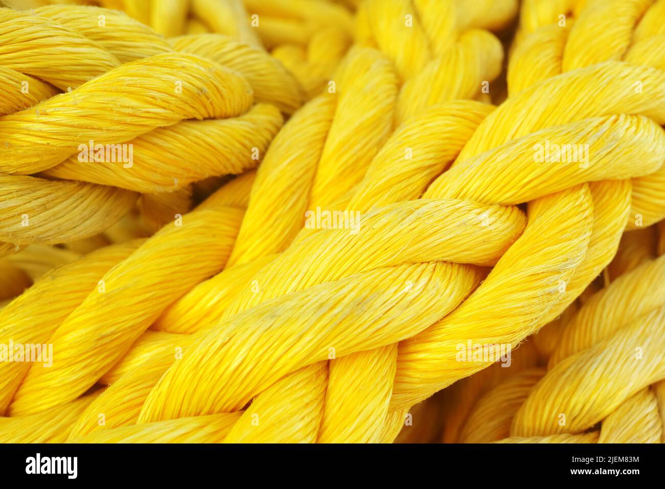 Closeup of a strong and colorful yellow rope. New heavy duty marine ...