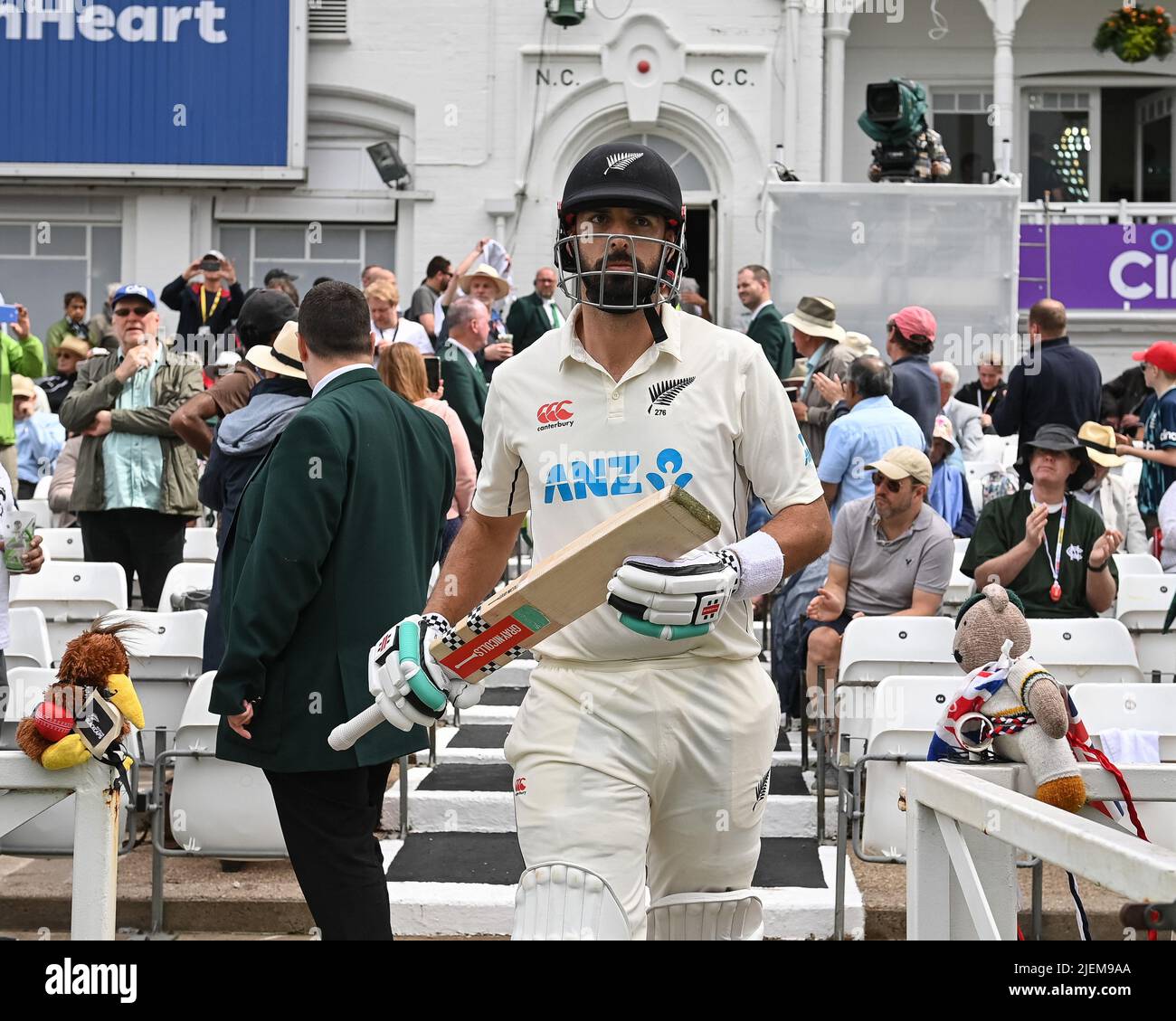 Daryl Mitchell of New Zealand heads back out after play resumes during ...