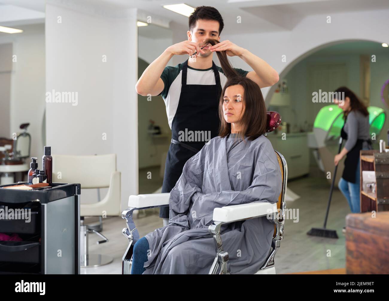 Female barber haircut doing male hi-res stock photography and images ...