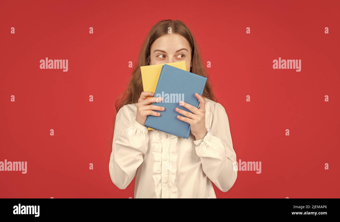 kid in white shirt ready to study do homework behind book on red ...