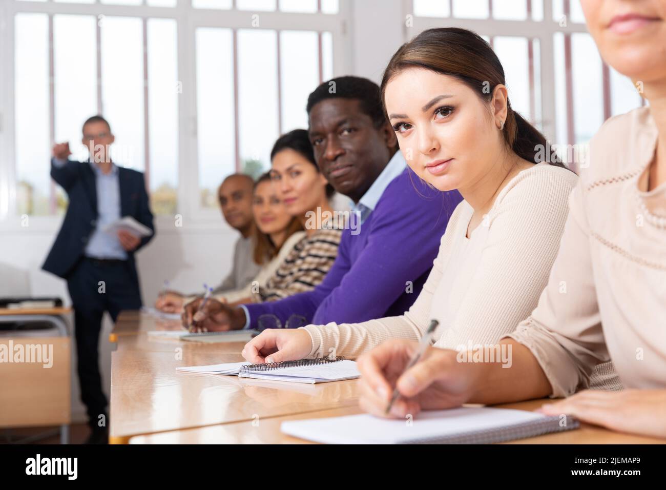 Side view of student group working on lecture in classroom Stock Photo ...