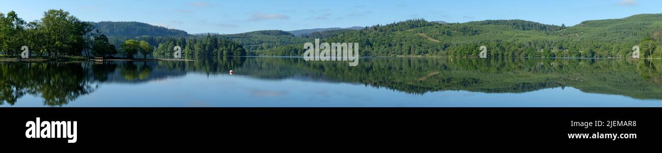 Loch view, Highlands of Scotland, UK. The trees overlooking the loch ...