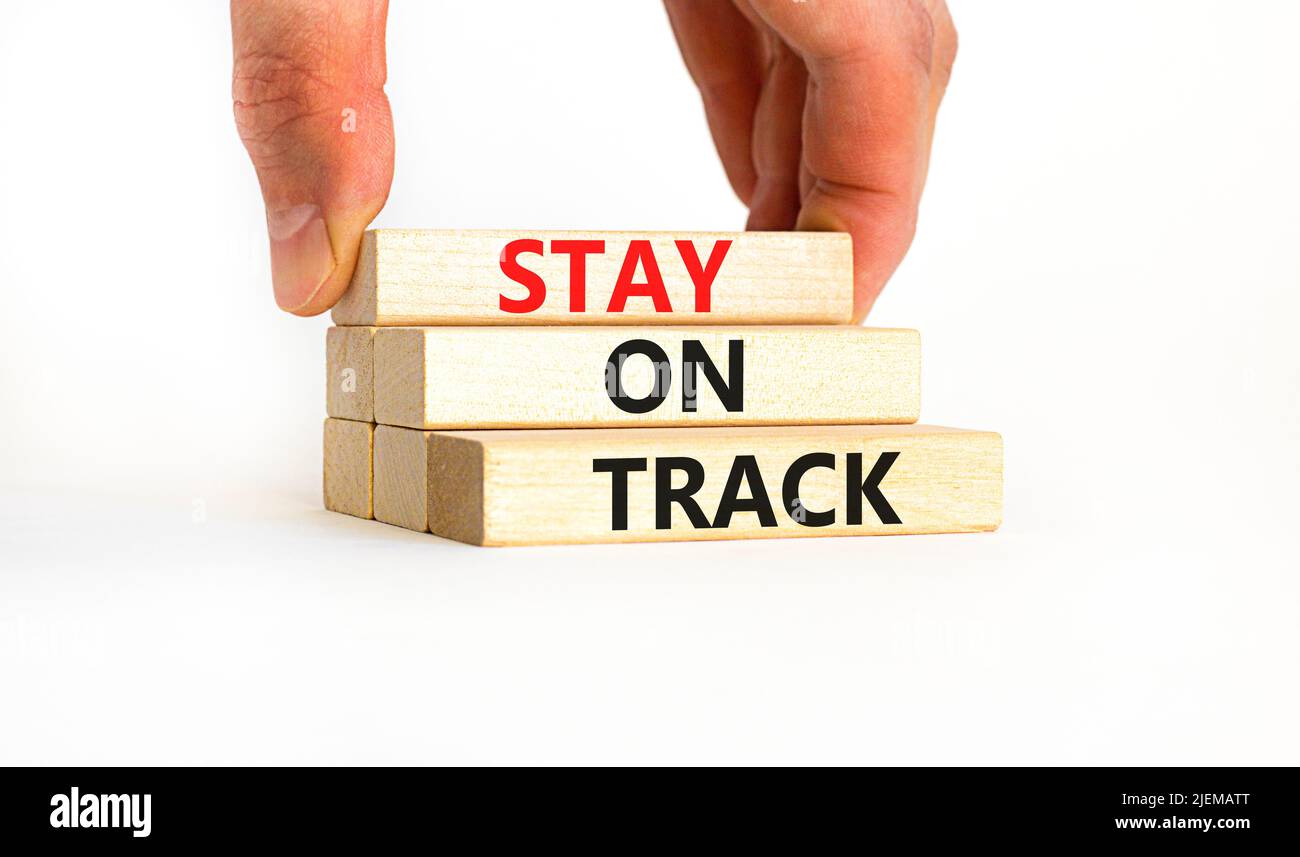 Stay on track symbol. Concept words Stay on track on wooden blocks on a ...