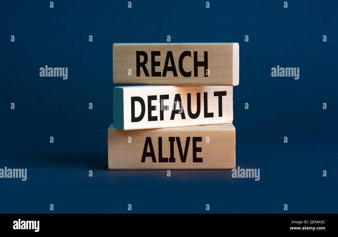 Reach default alive symbol. Concept words Reach default alive on wooden ...