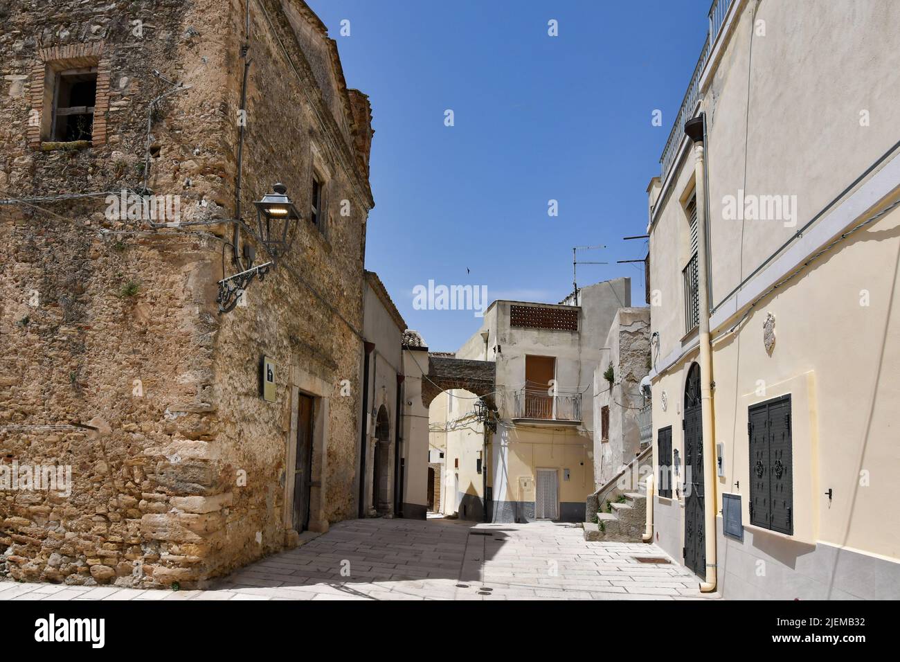 A narrow street among the old houses of Irsina in Basilicata, region in ...