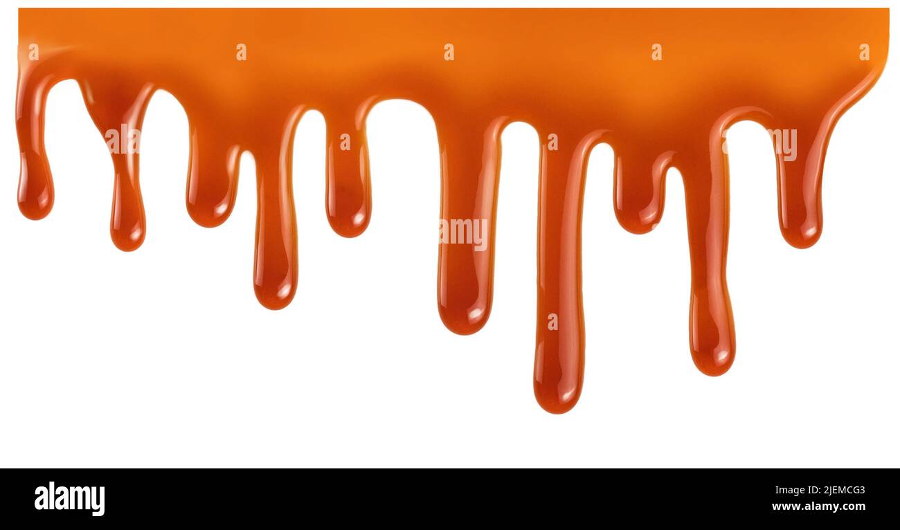Dripping caramel drops of sweet sauce isolated on white background ...