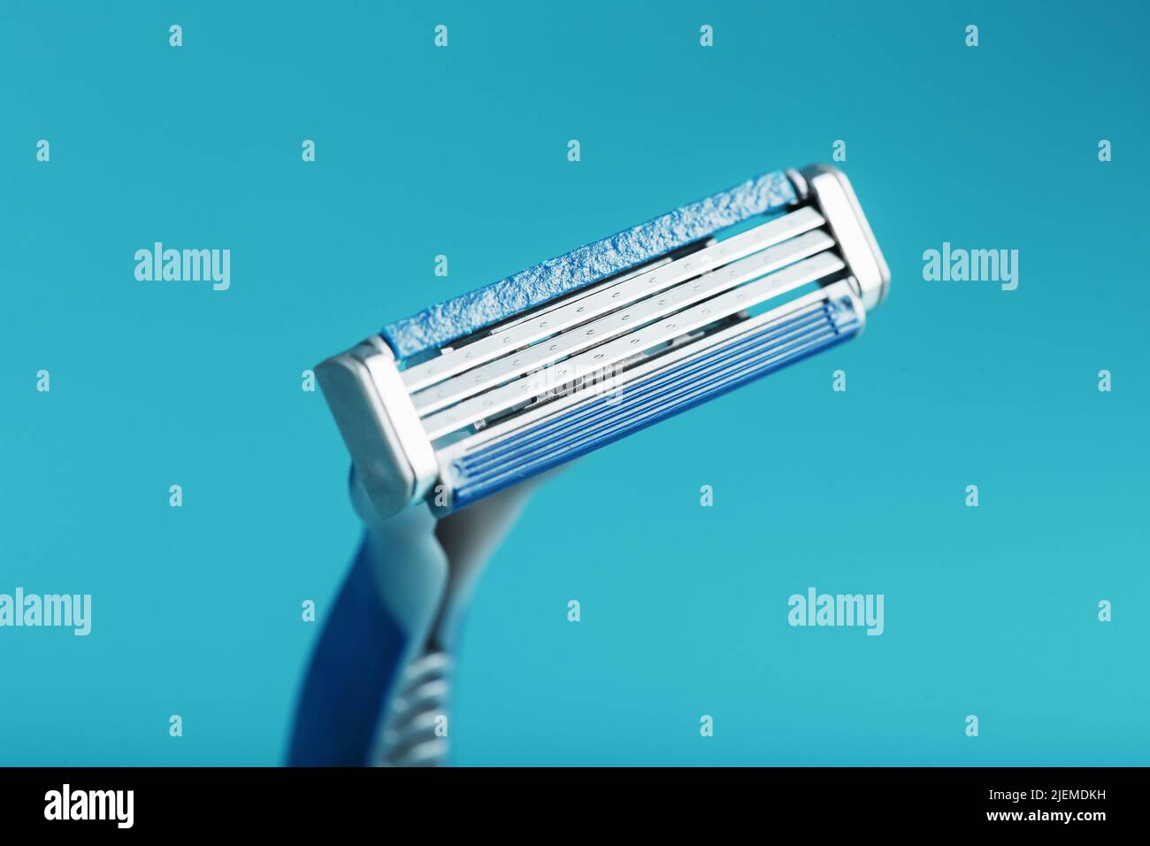 Three shaving machines on a blue background with free space, top view ...