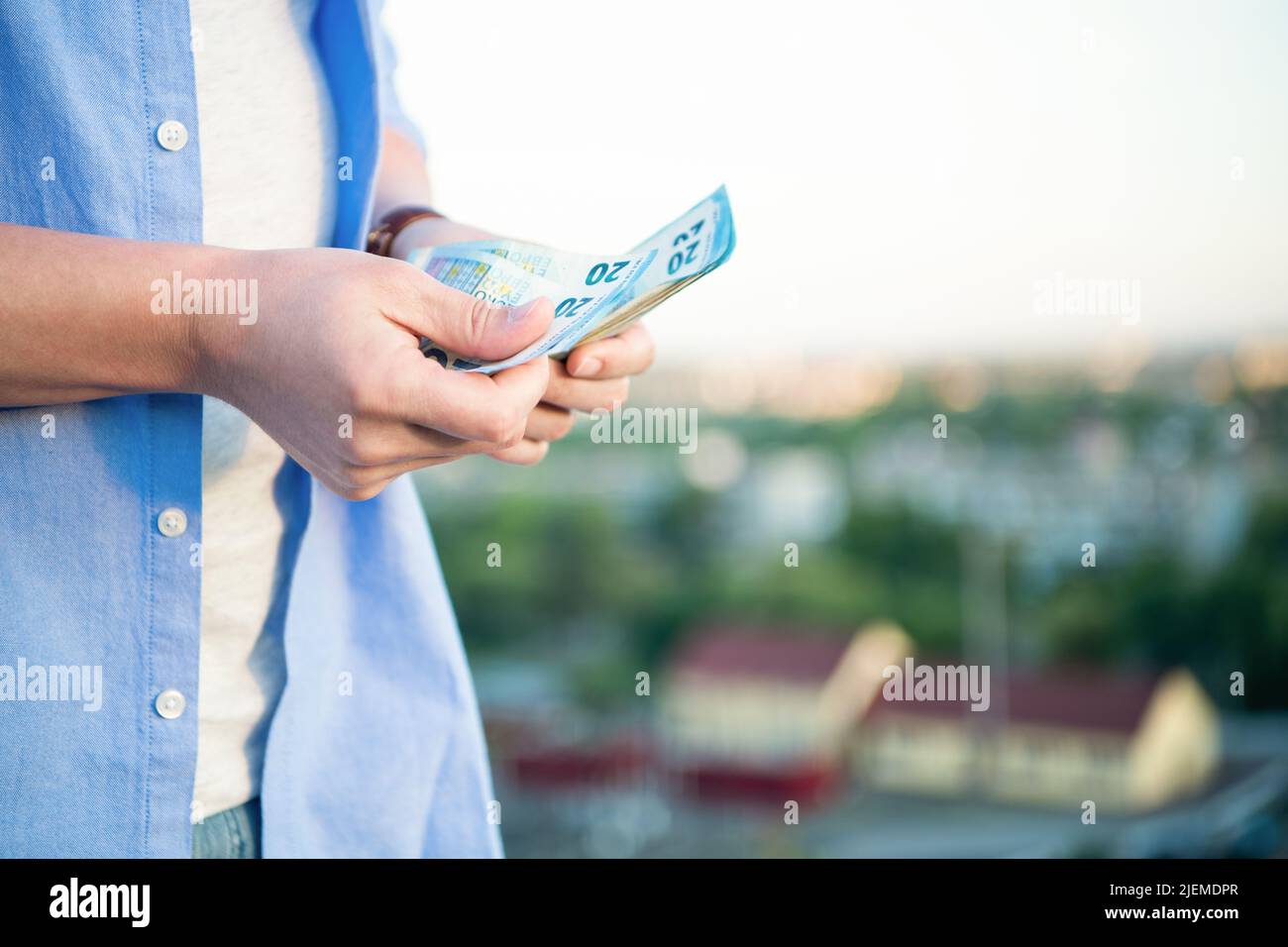 Man crop view counting cash money banknotes blur outdoors, copy space ...